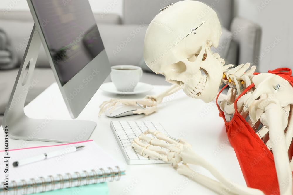 Human skeleton in red dress using computer at table Stock Photo | Adobe ...