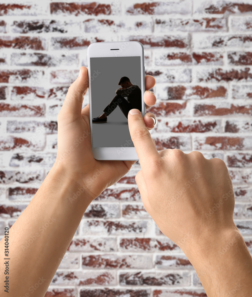 Young man holding mobile phone on white background Stock Photo | Adobe ...