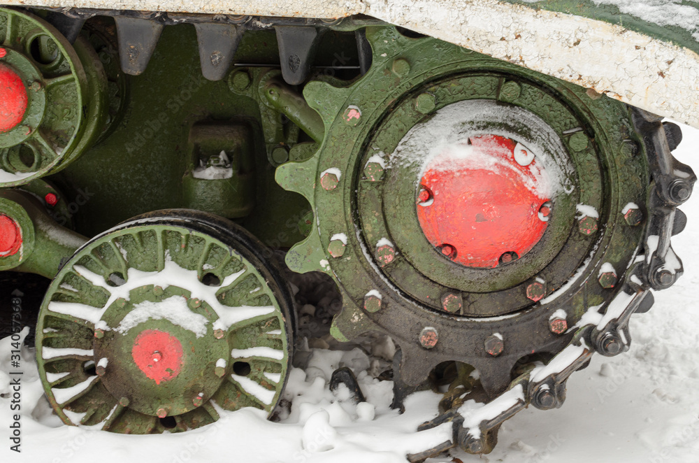 Elements of a tank suspension close-up. Green tank details in winter ...