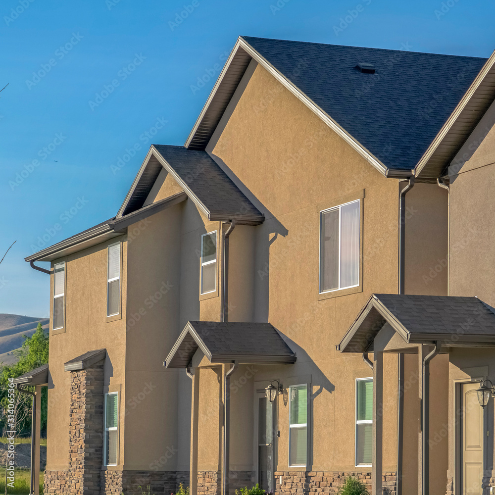 Square frame Facade of homes with concrete and brick wall and porticos ...