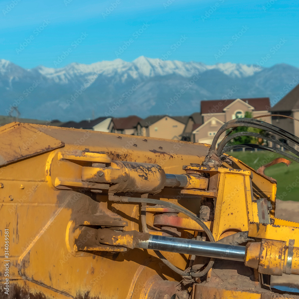 Square Yellow bulldozer with close up view of the mechanism at the back ...