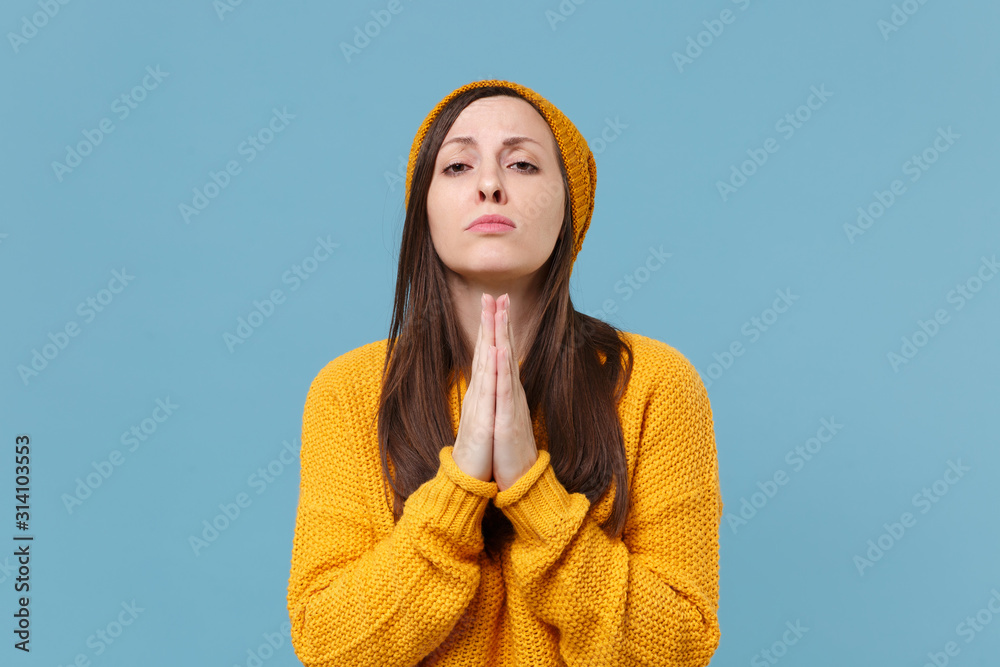Pleading young woman girl in yellow sweater and hat posing isolated on ...