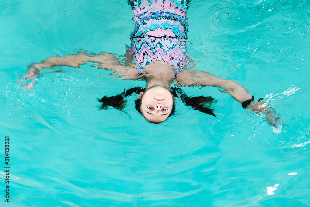 Girl swim in the pool. Happy girl play in the pool.Beautiful girl swim ...