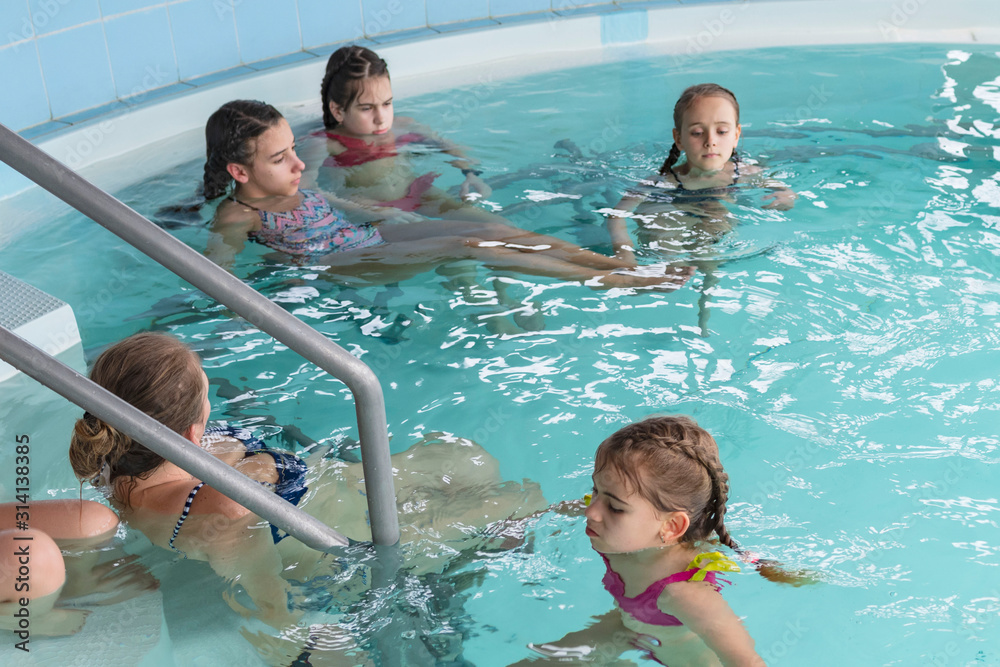 Girls swim in the pool. Happy girls play in the pool.Beautiful girls ...