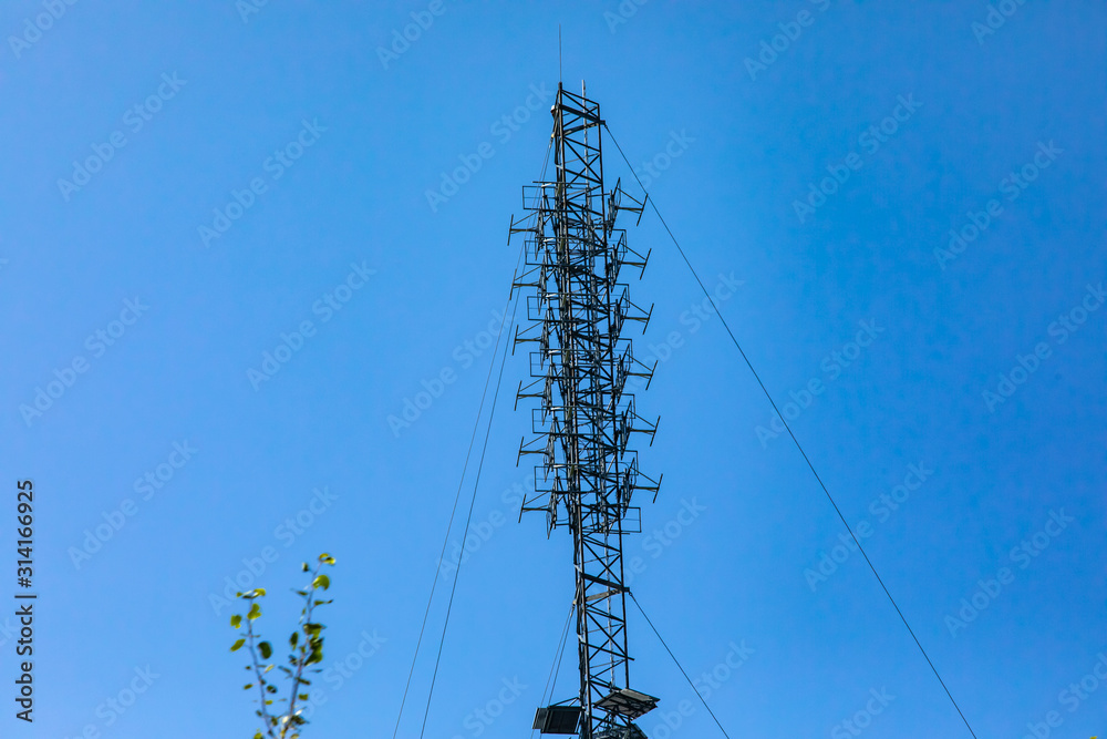 An antenna array is seen attached to a cable stayed steel lattice tower ...