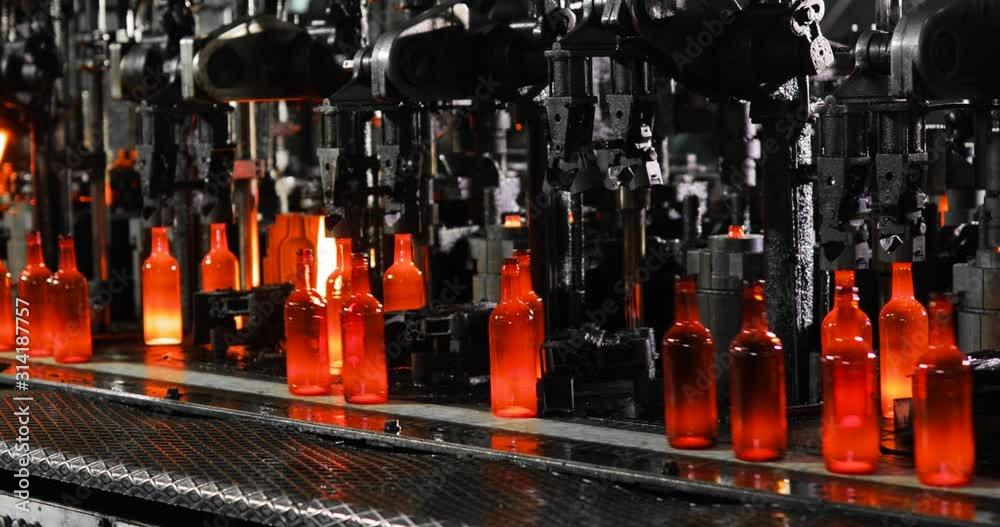 Automated process of forming bottle of molten glass. Molten glass mass ...