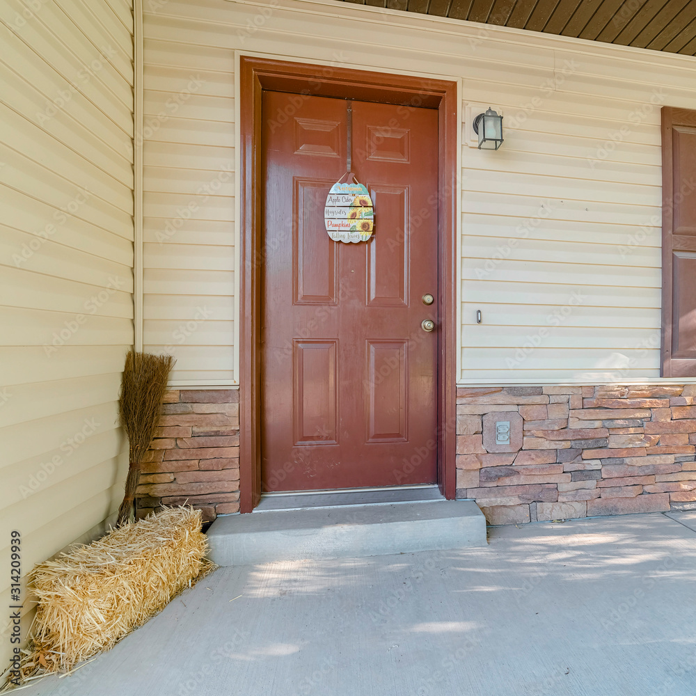 Square Home facade with white siding and stone bricks wall and ...