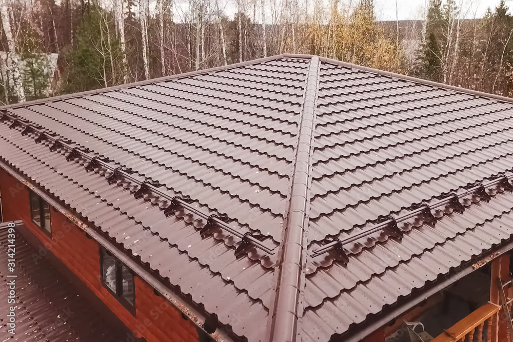 House with a brown metal roof.Corrugated metal roof and metal ro Stock ...