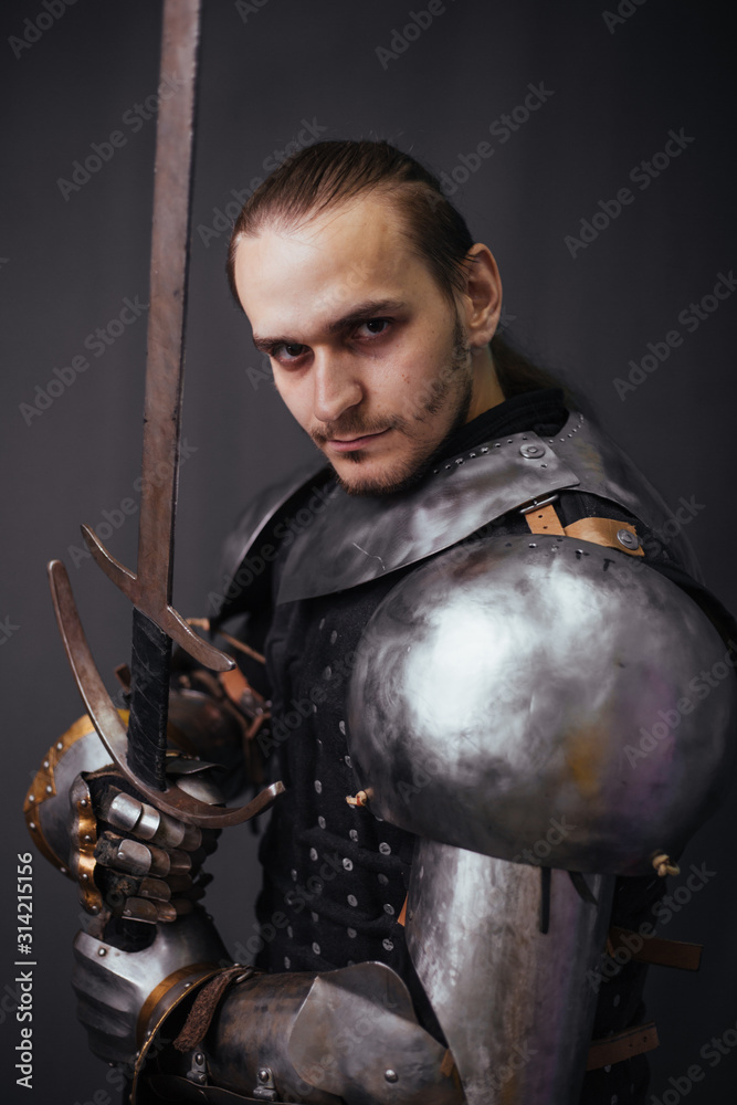 Portrait of a medieval knight with a two-handed sword. Warrior in the ...