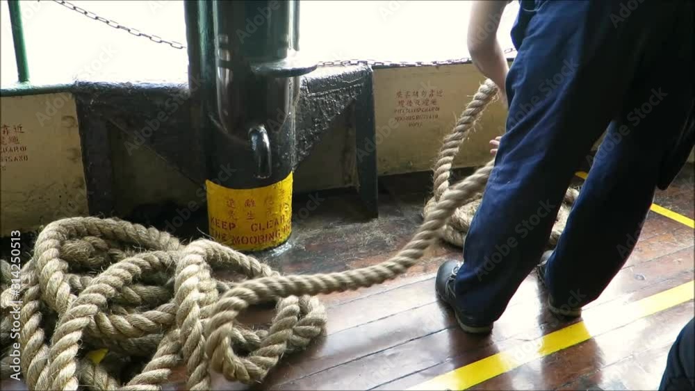 Sailor tidying rope as iconic Star Ferry leaves pier on Kowloon side of ...