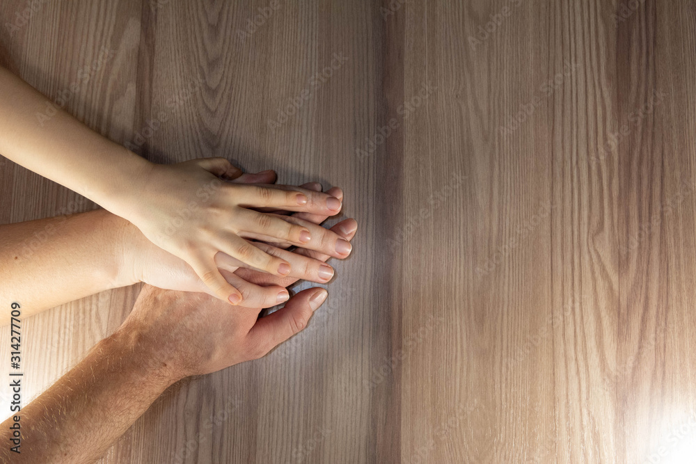 Foto de Family hands clasped together. The palms of dad, mom and son ...