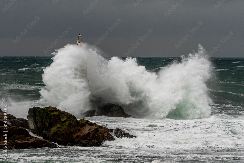 Dramatic seascape. Huge waves hit the lighthouse during severe sea ...