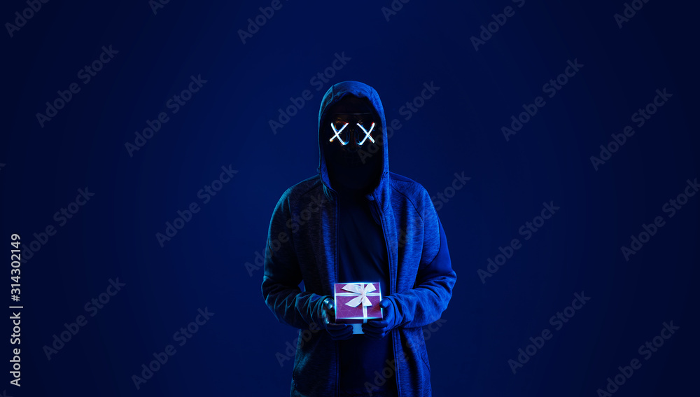 Dangerous hooded hacker with gift in hands. Internet, cyber crime, cyber attack, system breaking ...