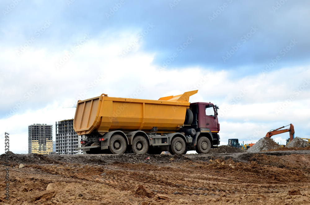 Dump truck transports sand and other materials at construction site ...
