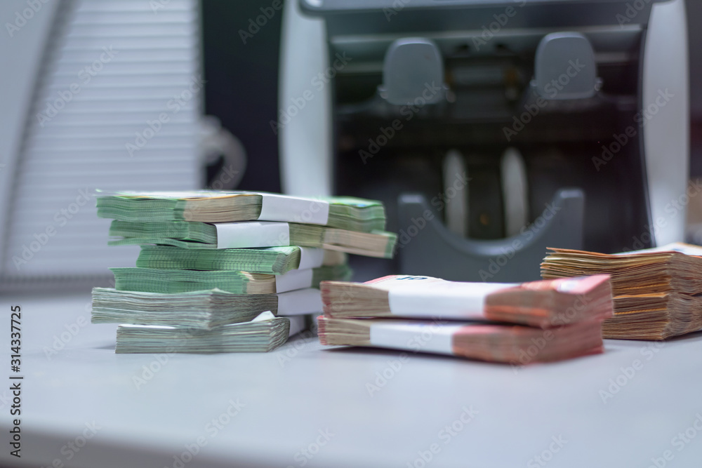 Bundles of banknotes divided into groups with currency straps placed on ...