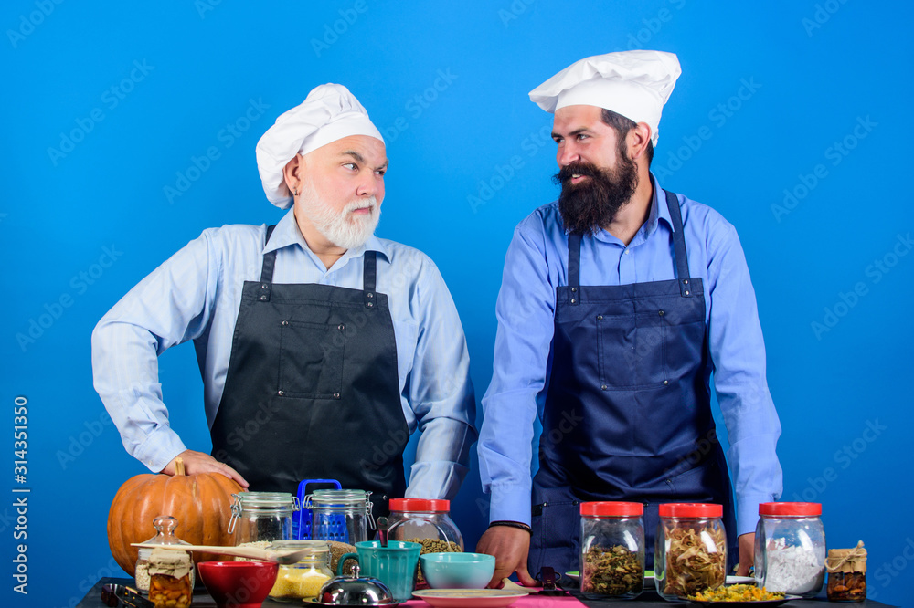 Family restaurant. Mature bearded men professional restaurant cooks ...