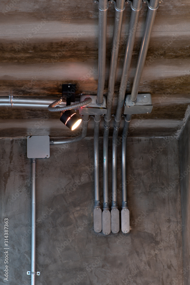 Electrical wiring work in a steel pipe of a house with a loft style ...