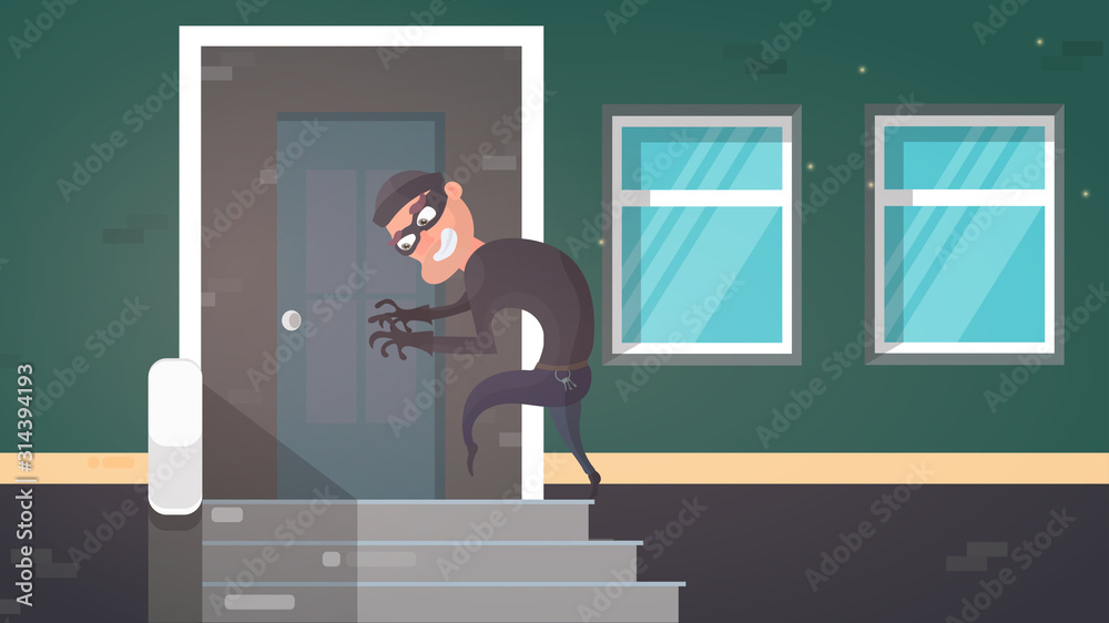The thief is sneaking into the house. The robber is trying to crack the ...
