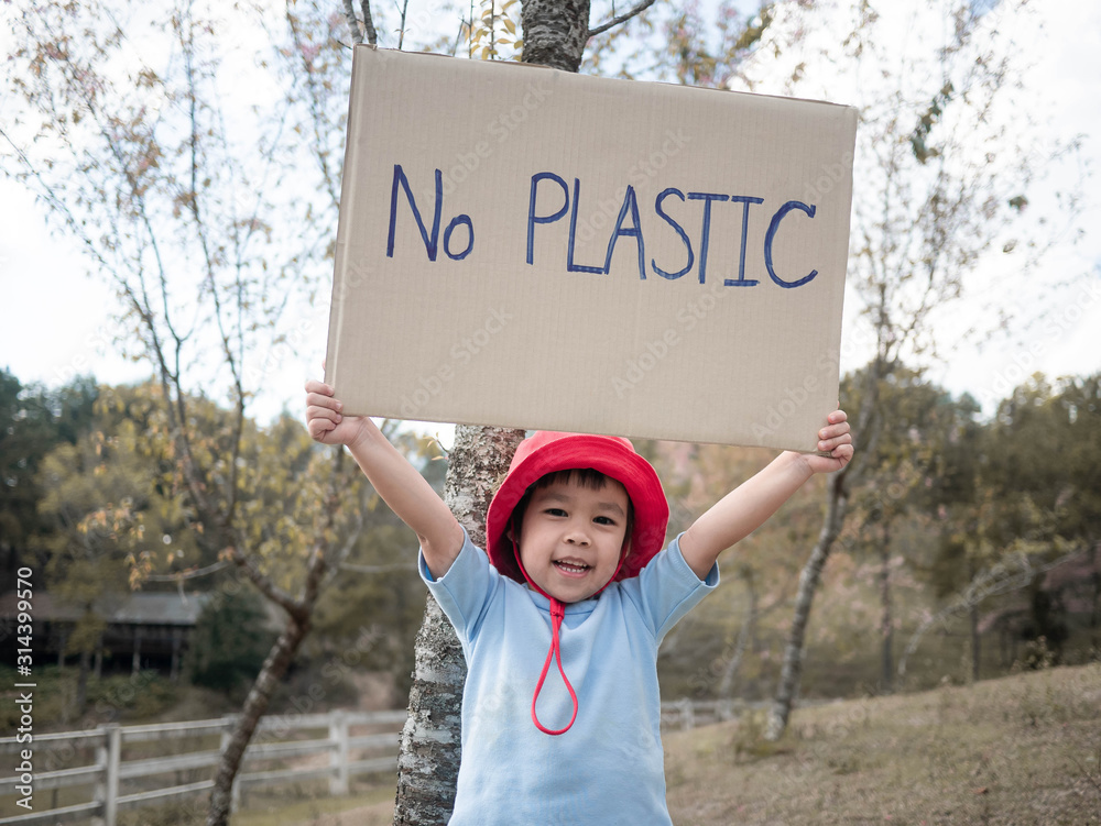 The little child girl holding "No Plastic" Poster showing a sign ...