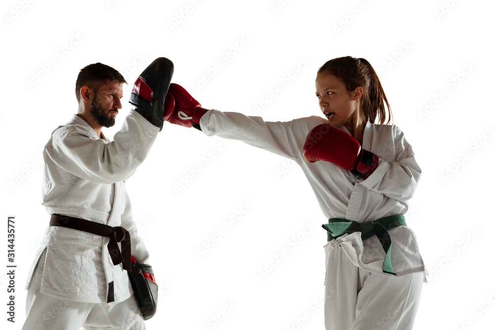 Junior in kimono practicing hand-to-hand combat with coach, martial ...