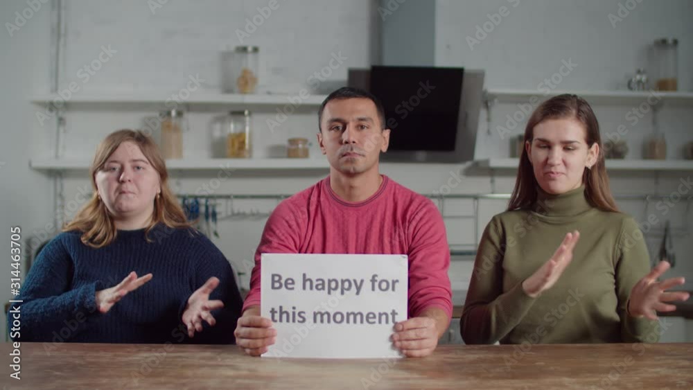 Cheerful caring diverse deaf people showing positive slogans , written ...