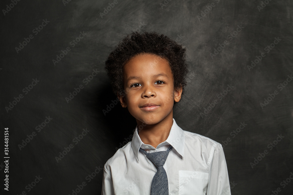 Happy black kid school boy. Smart child on blackboard background ...