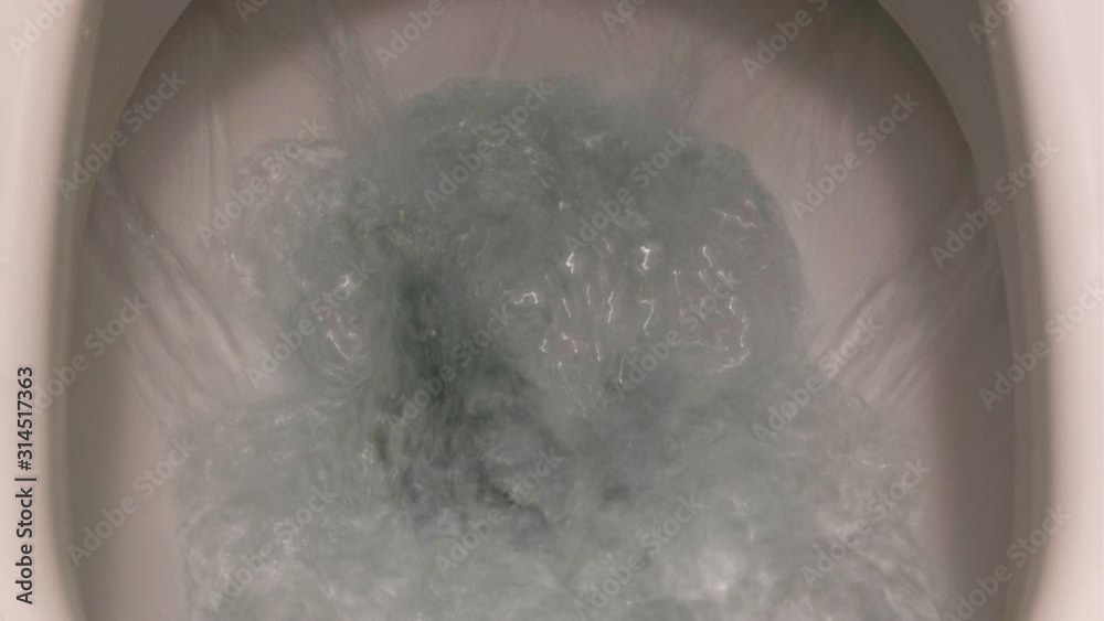 Toilet Flushed Top View. Close-up view of a Water flushing down into ...
