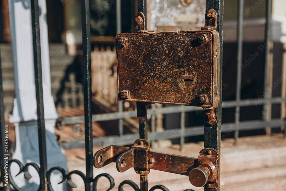 Old rusty castle on the forged gates of the old fence Stock Photo ...