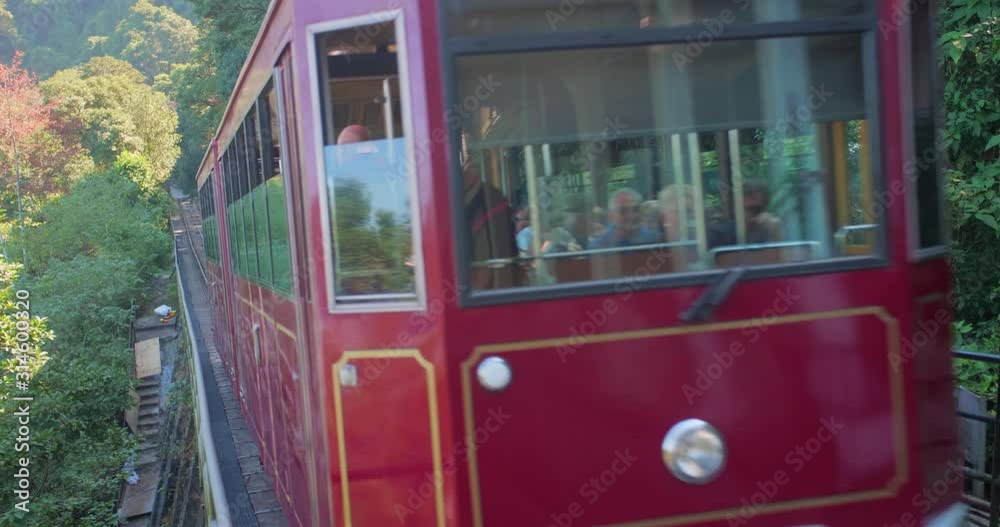 The Peak Tram funicular cable-car railway going down the track, Hong ...