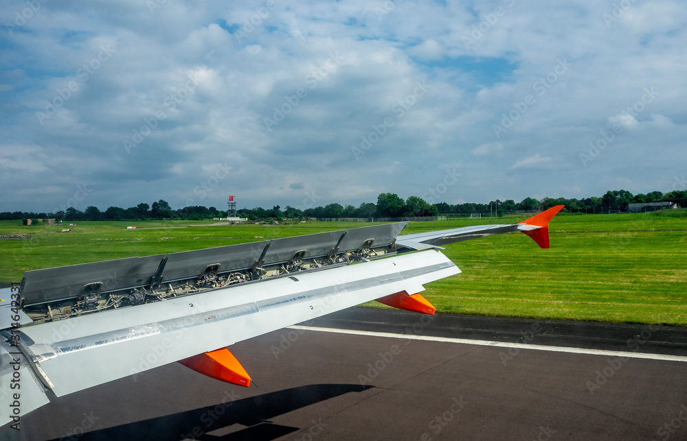 Aircraft wing with extended flaps and spoilers while landing on the ...