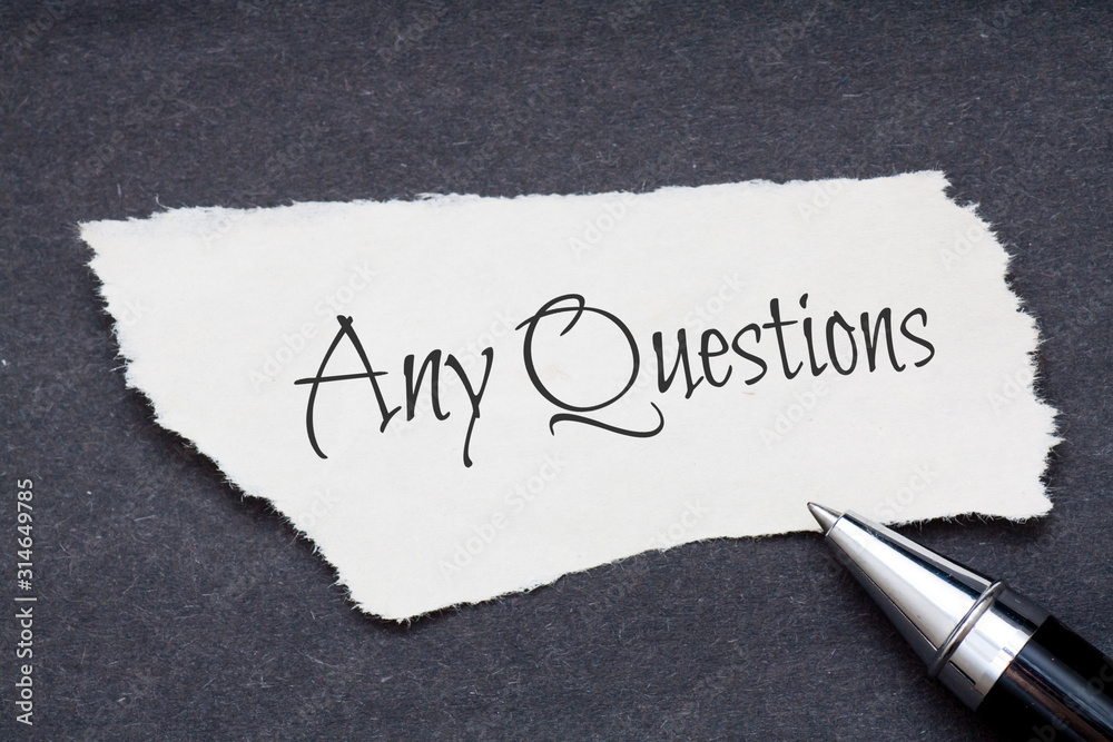 Any Questions? word,concept: Torn paper on black background with pen ...