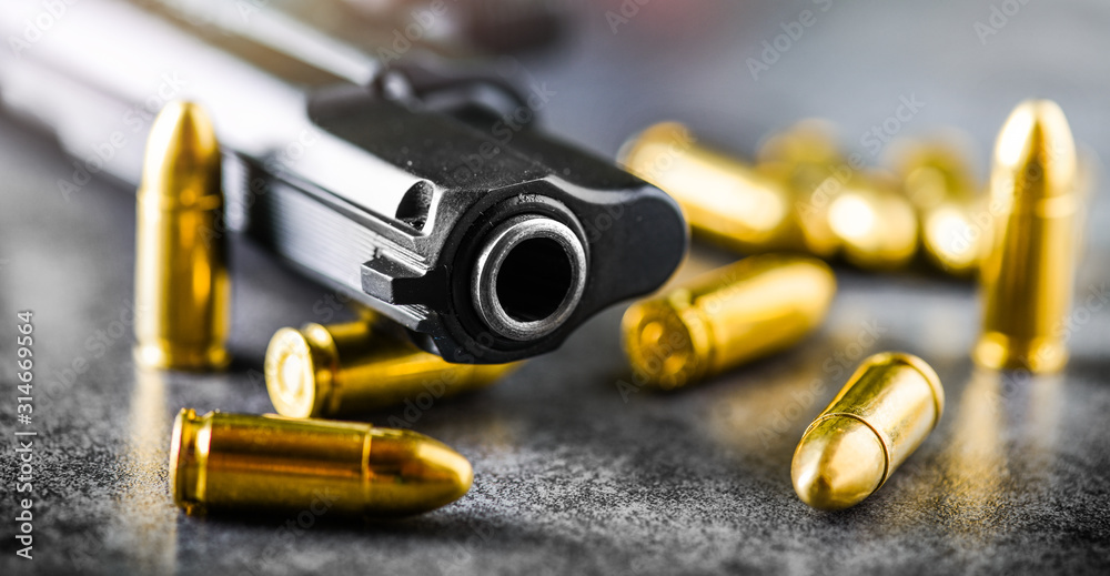 Hand gun detail with ammunition on stone table banner or panorama photo ...