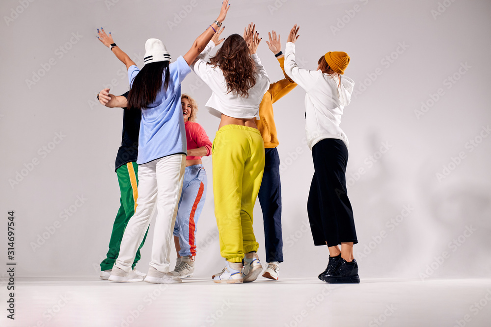 Smiling cheerful group of dancers hugging gladly after performance ...