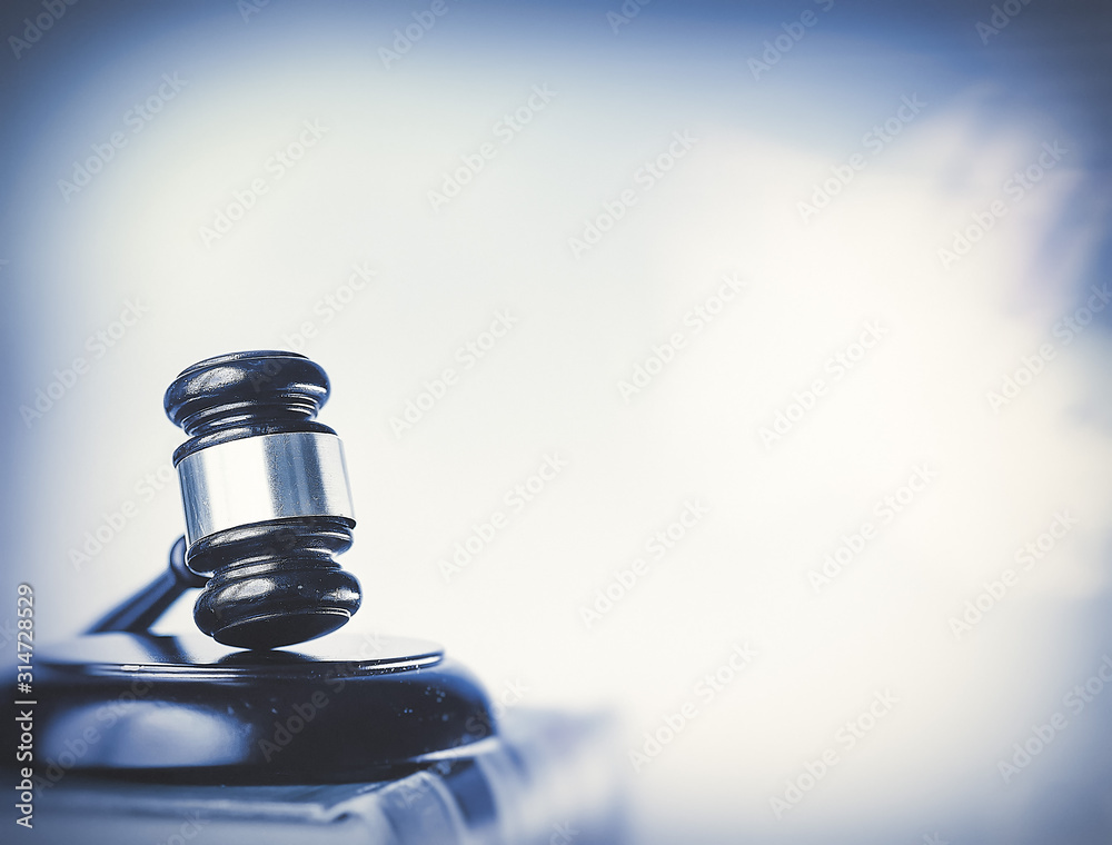 Law concept image, gavel set against bright computer monitor screen ...