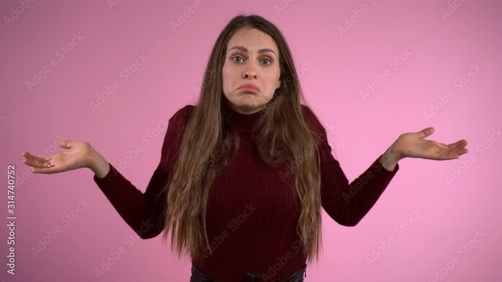 Portrait of attractive young long hair woman feeling perplexity and misunderstanding emotions ...
