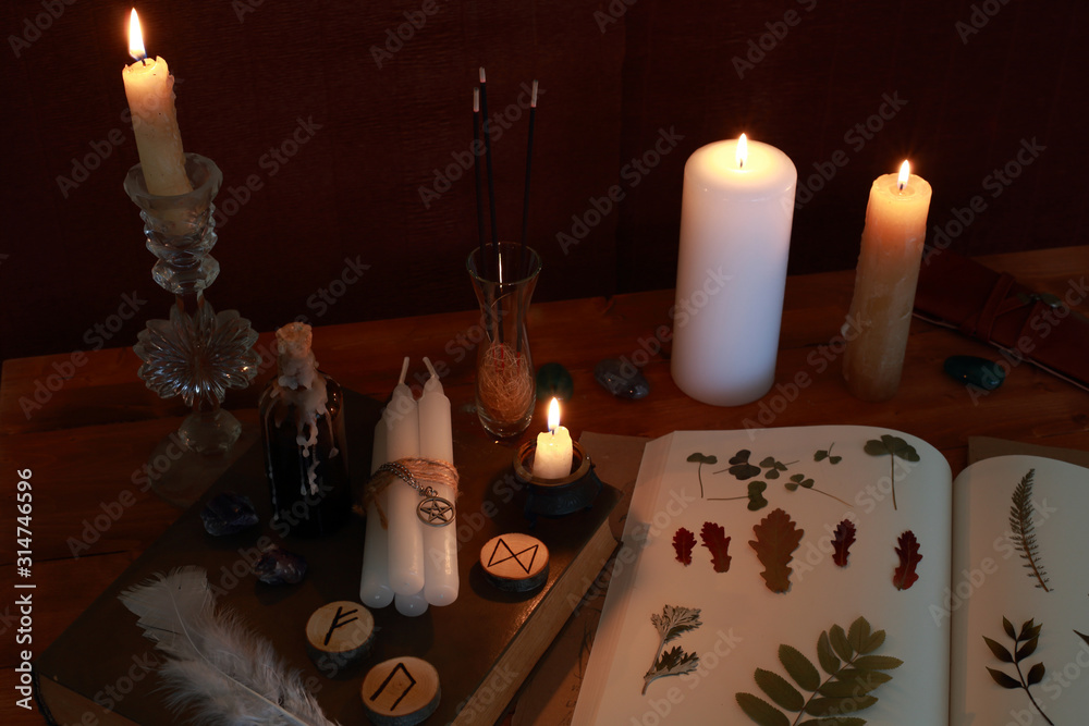 Foto de magic ritual of the alchemist with candles, runes and symbols ...
