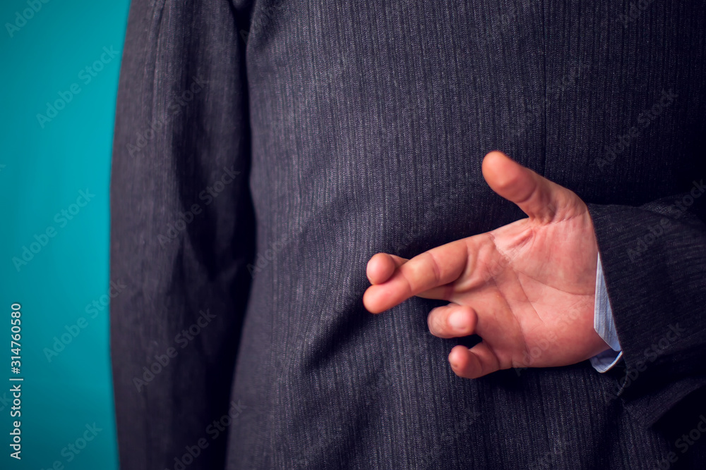 Black Fingers Crossed Behind Back