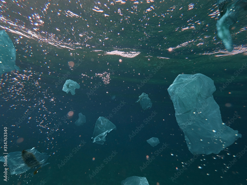 Toxic plastic waste floating underwater in the ocean Stock Photo ...