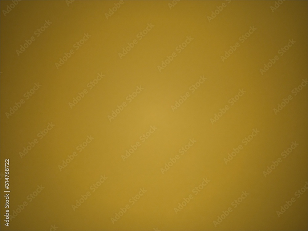 Ocher color background. Colored paper dimly lit in the middle. Light ...