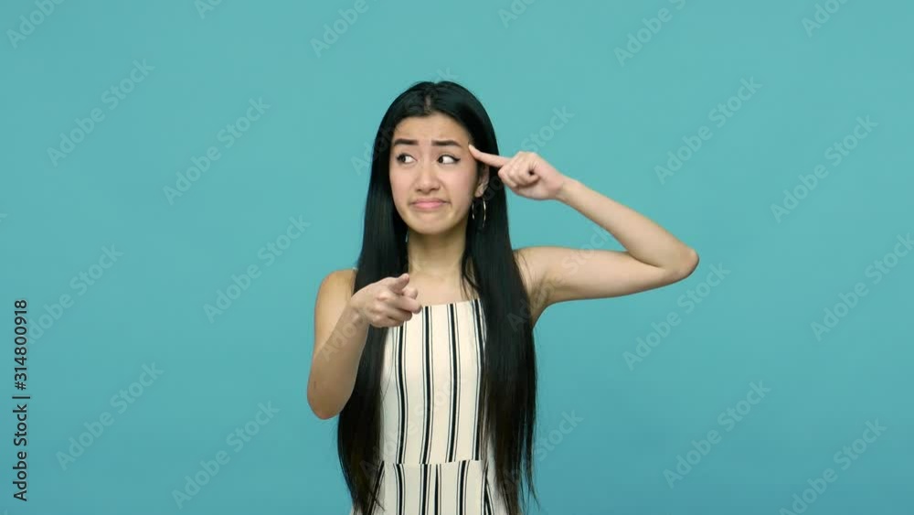 You are idiot! Displeased asian woman with long black hair twisting ...