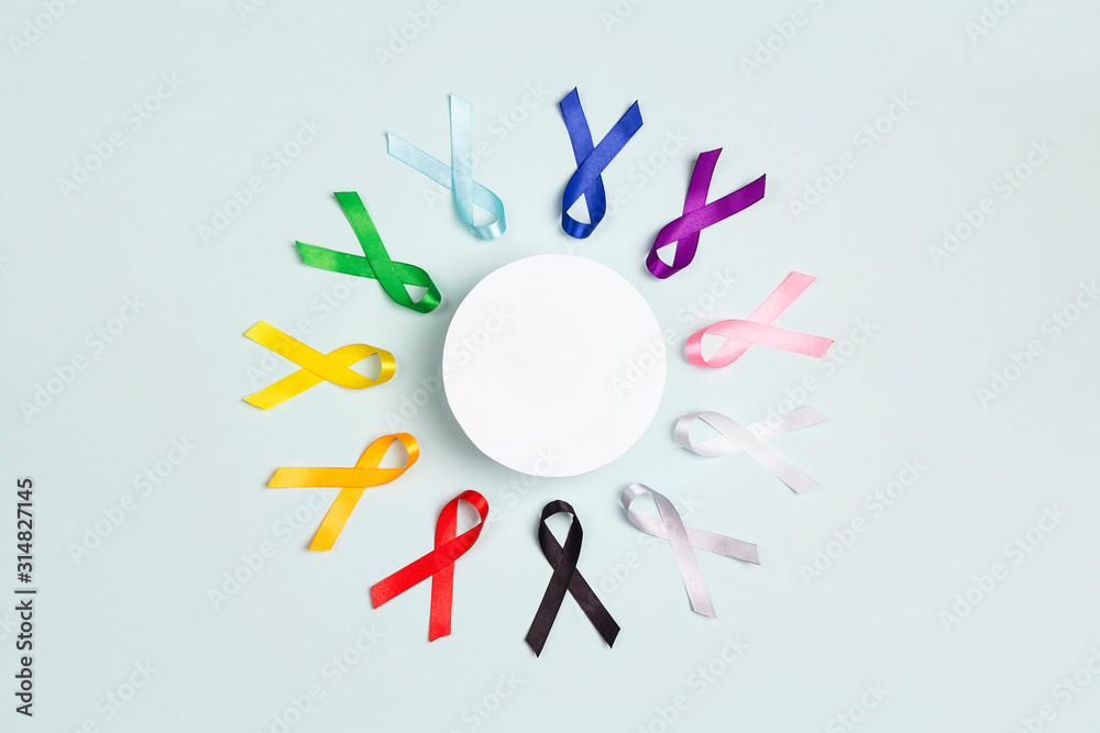 Circle of colorful awareness ribbons with place for text on blue ...