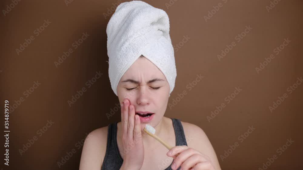 Close up portrait young woman with towel wrapped around her head while ...