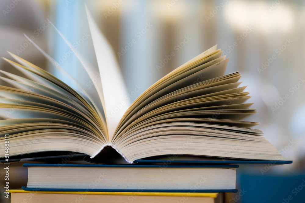 Open book lying on the table in the library Stock Photo | Adobe Stock