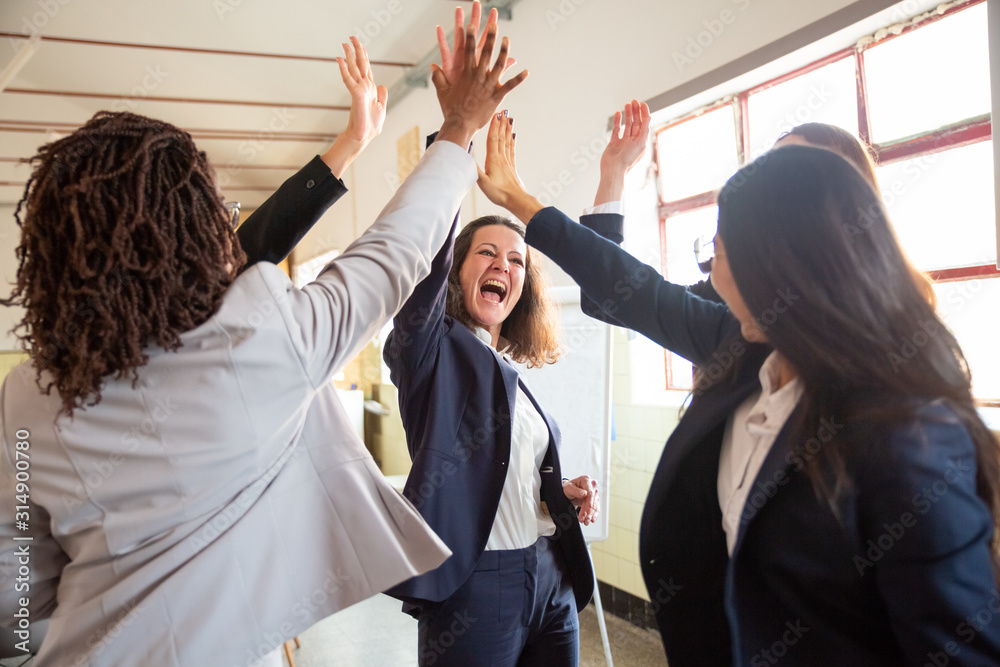 Successful creative business team giving high five. Group of young ...