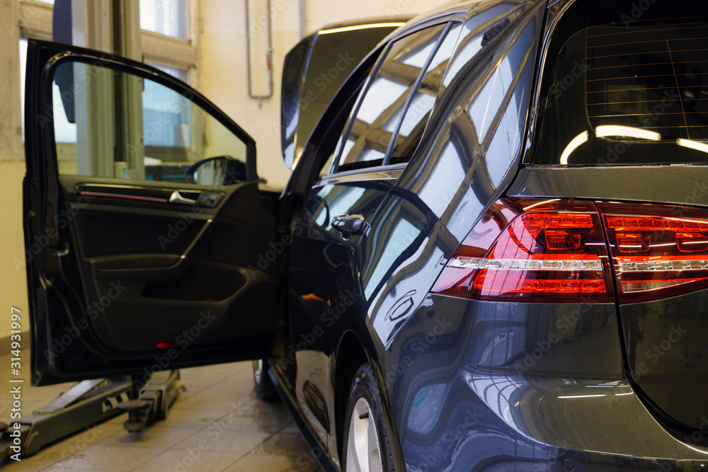 A modern car in a quality dealership service. Car rear view, close-up ...
