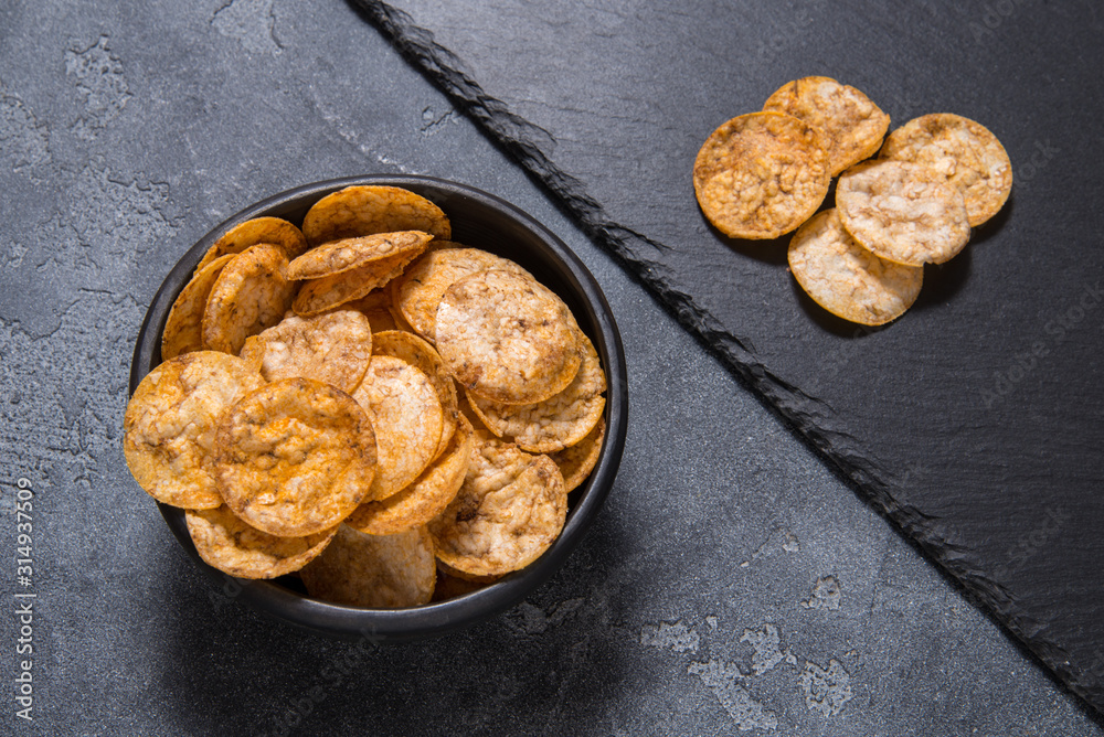 Top view pile of organic, crispy, baked, whole grain rice chips with ...