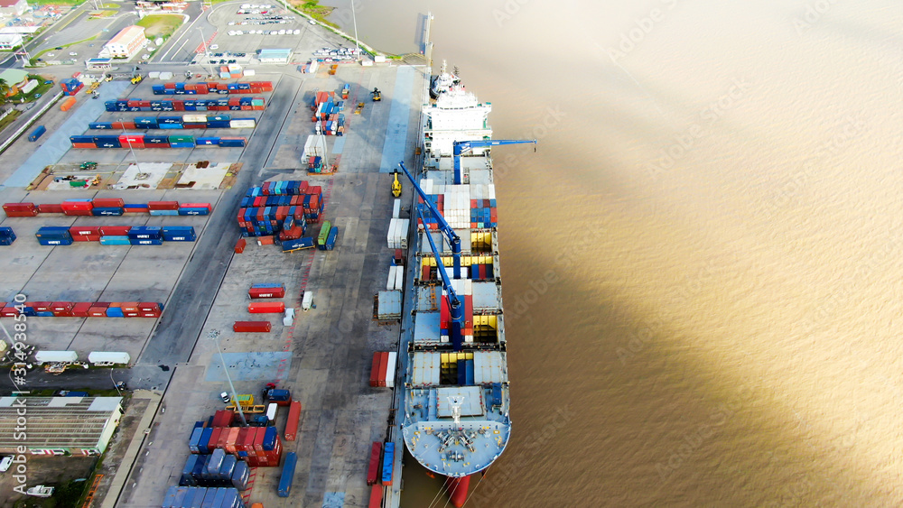 Feeder french container ship with cargo cranes has loading operations ...