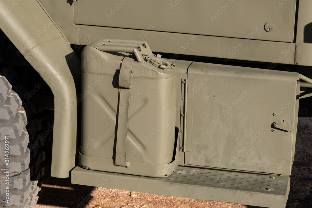 Green military jerrycan or fuel canister on a military truck closeup ...