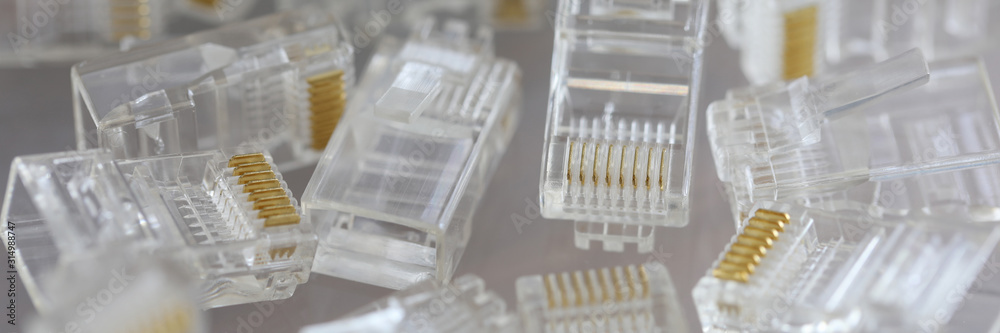 Focus on many curved plastic ethernet cable lying on transparent table ...