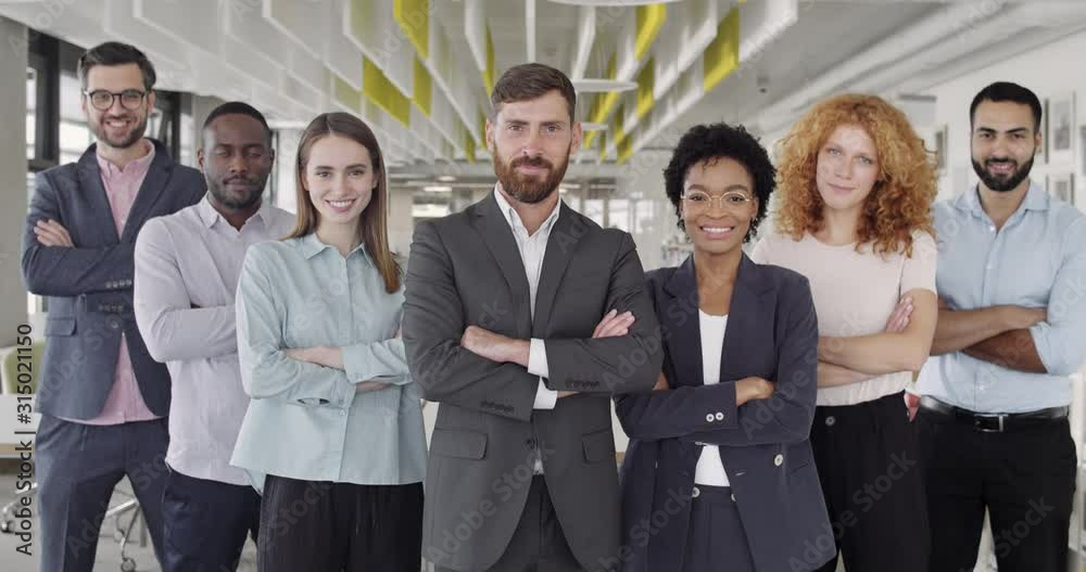 Positive multiracial company staff standing and crossing hands in ...